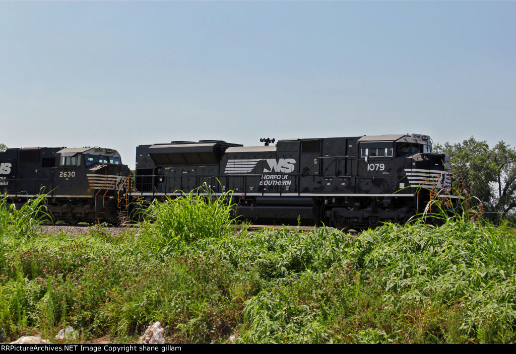 NS 1079 Sits tied down on a loaded coal train.